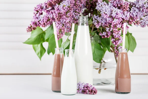 Sweet chocolate milkshakes and beautiful lilac flowers - Stock Image ...