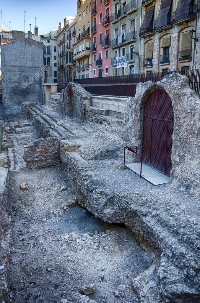 Roman ruins are preserved between modern buildings in Tarragona, Spain ...