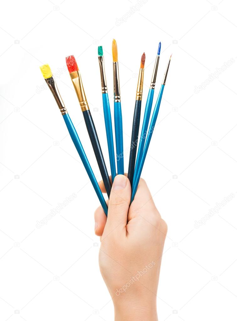Hand holding paint brushes Stock Photo by ©OlyPhotoStories 111789986