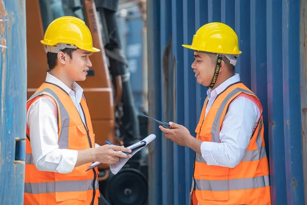 Professional engineering men workers talk and stand in container ...
