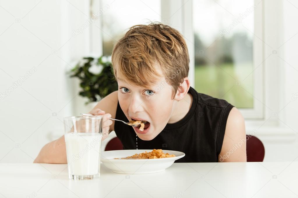 Teenage Boy Eating Breakfast Cereal in Morning — Stock Photo ...