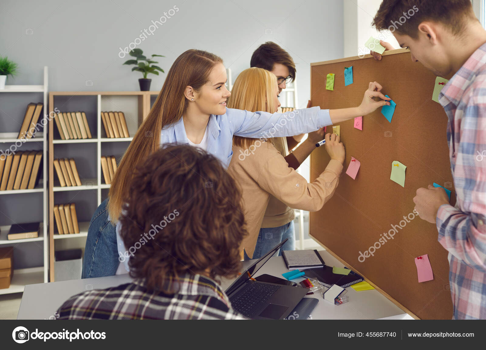 School, college or university students brainstorming while working on ...