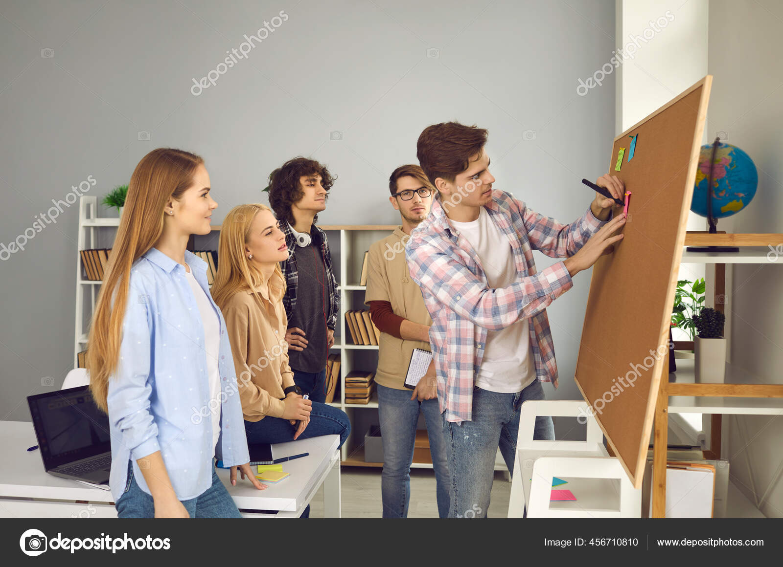 College students working on team assignment and brainstorming in search ...