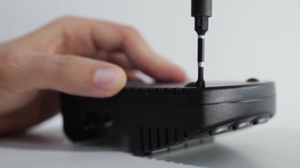 Close up male hands unscrewing the board in black plastic sase with ...