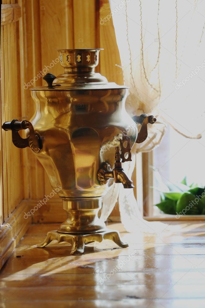 Old samovar next to window Stock Photo by ©Amvorsuf 111771884