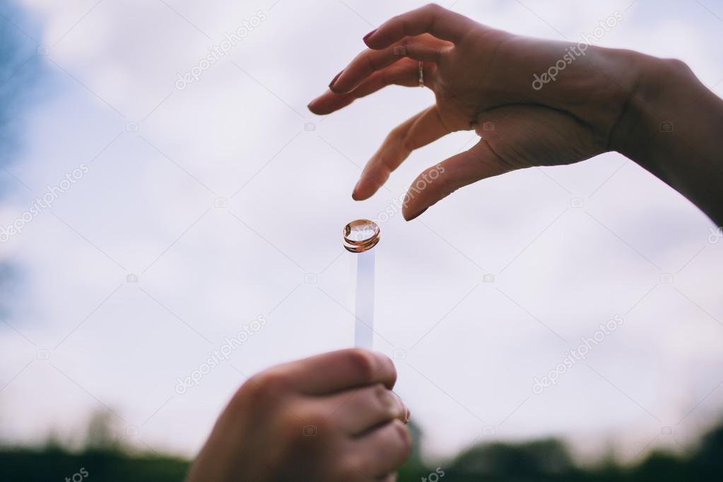 Hands holding wedding rings Stock Photo by ©Amvorsuf 114344400