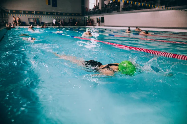 People swimming in indoor pool Stock Photo by ©Amvorsuf 119969374