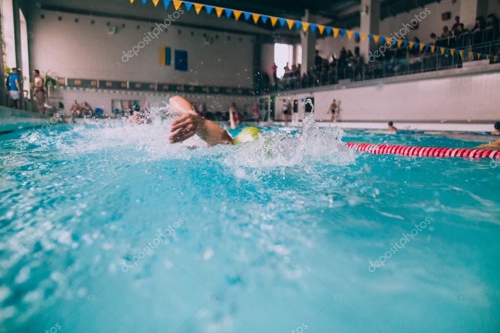 People swimming in indoor pool Stock Photo by ©Amvorsuf 119969372