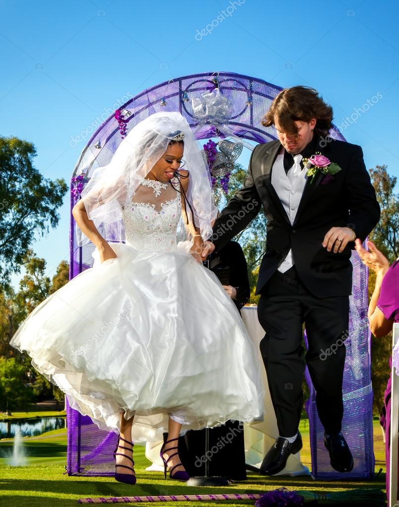 Bride and Groom Jump Broom — Stock Photo © jbrown777 #112679494