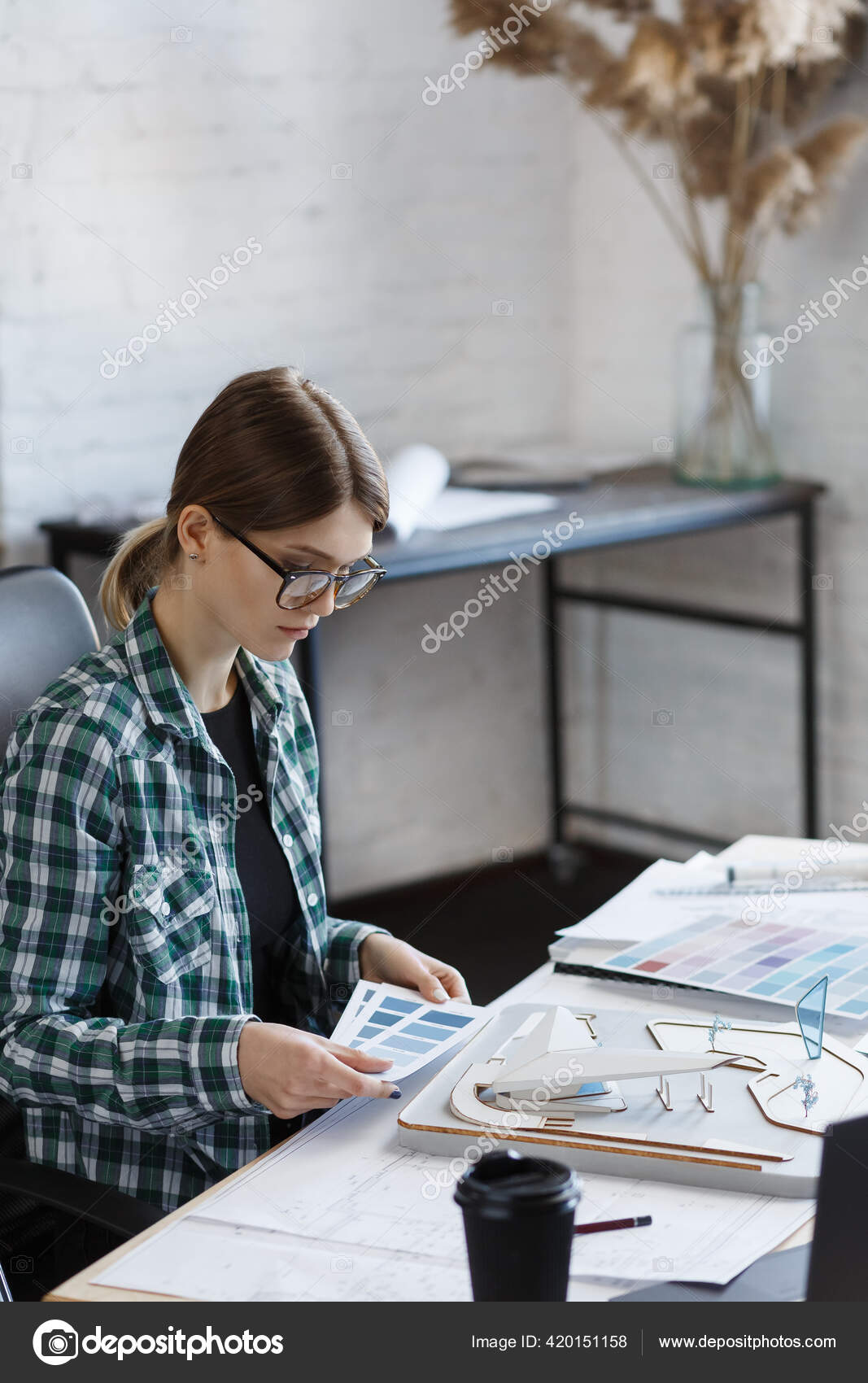 Female interior designer working in office with color palette ...