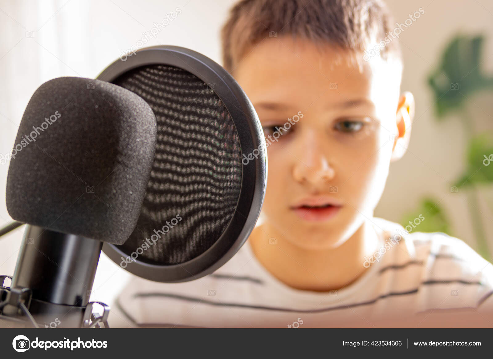 Kid talking into microphone. Techology, online learning, remote ...