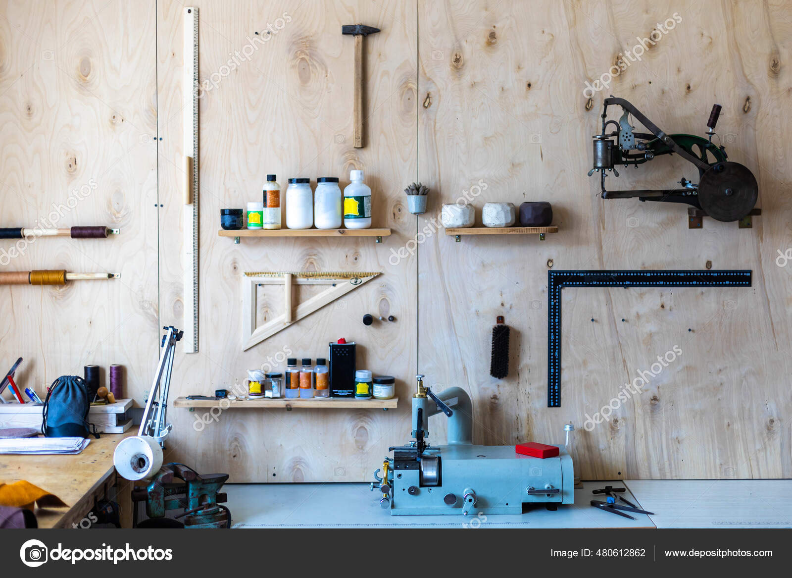Wooden wall at leather workshop. Different tools and equipment for ...