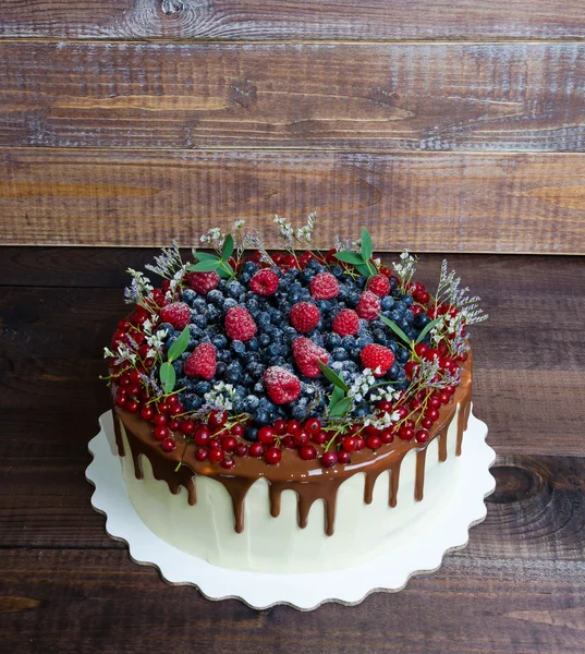 Delicious chocolate color drip cake with berries — Stock Photo ...