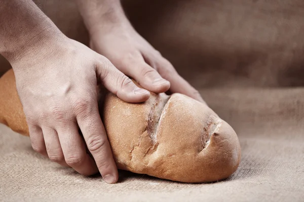 Male hand touching bread loaf Stock Photo by ©massonforstock 148337093