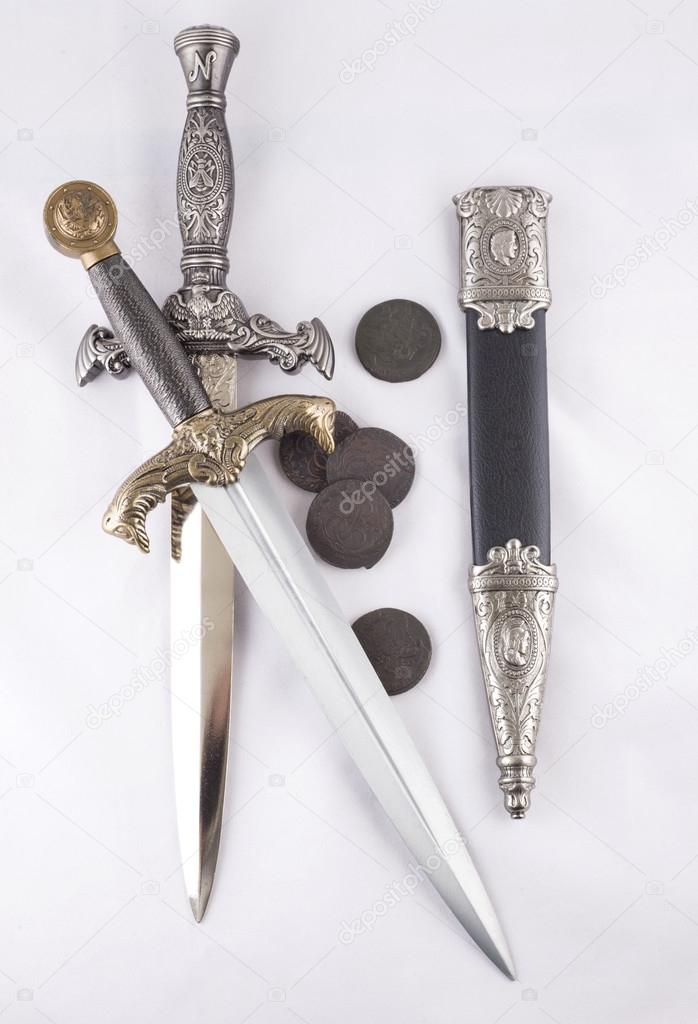 Military daggers and coins on white background Stock Photo by ...