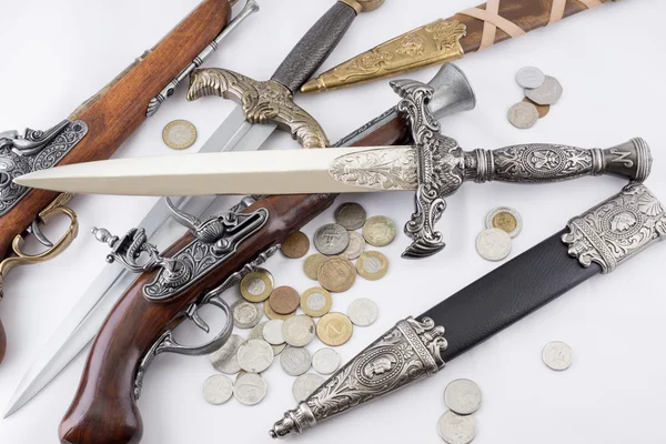 Military daggers and coins on white background Stock Photo by ...