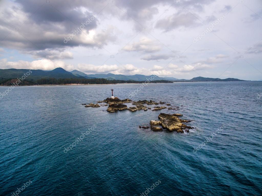 Small island with a lighthouse in the sea — Stock Photo © fotodrug ...