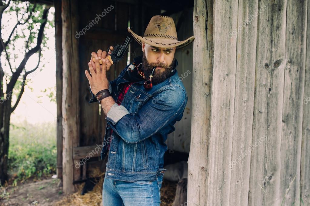Bearded cowboy with gun — Stock Photo © anatoliycherkas #121089420