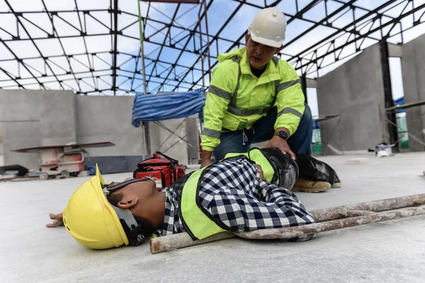 Accident at work of construction worker at site. Builder accident falls ...