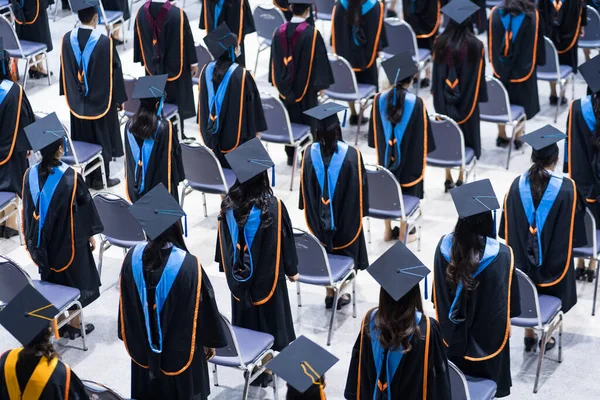 Rearview of the university graduates line up for degree award in ...