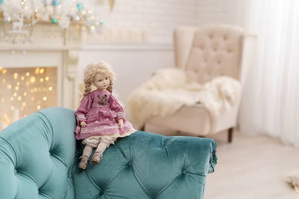 An interior doll with a human face, made by hand from textiles, in ...