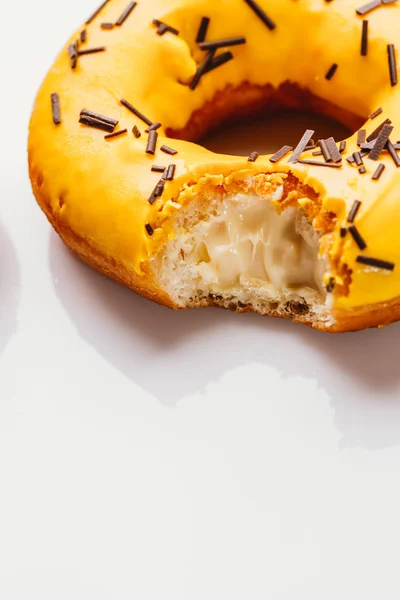 Bitten donut with banana cream on a white background Stock Photo by ...