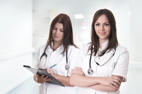 Two nurses looking in black folder Stock Photo by ©DuxX73 125336450