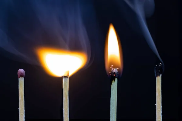 Matchstick on fire and extinguished isolated on black background ...