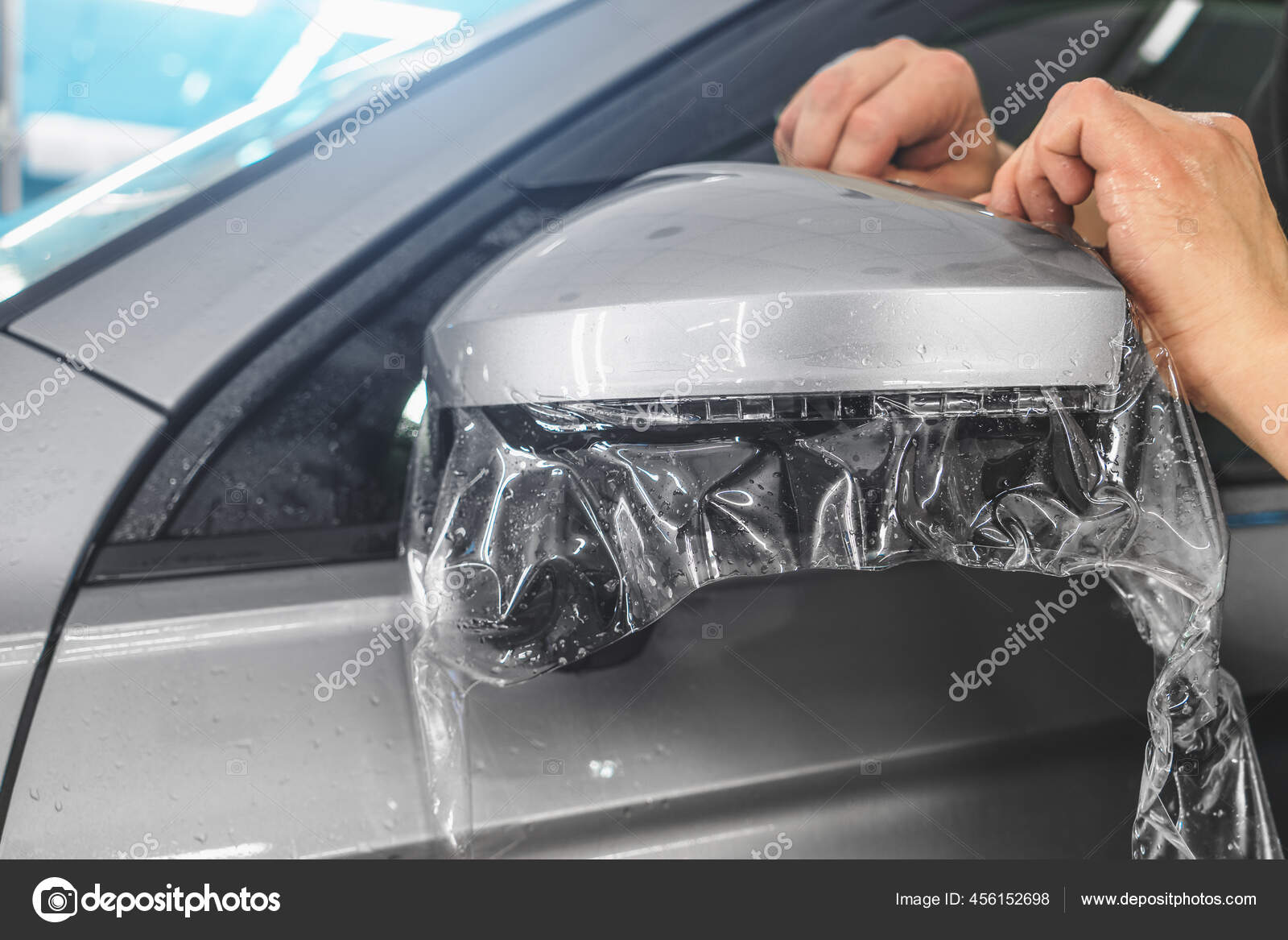 PPF installation on car side mirror. Paint Protection Film is ...