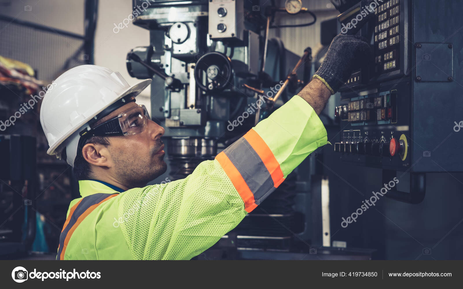 Smart factory worker using machine in factory workshop Stock Photo by ...