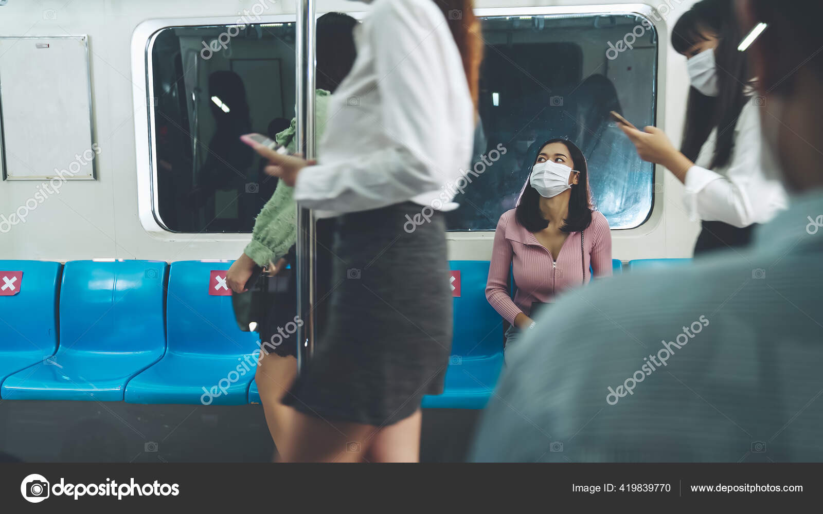 Crowd of people wearing face mask on a crowded public subway train ...