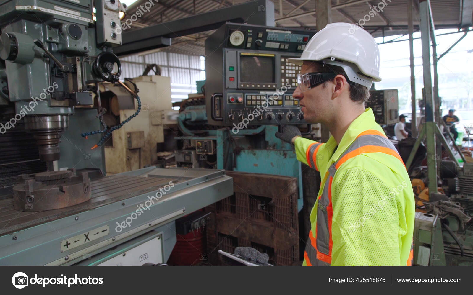Smart factory worker using machine in factory workshop Stock Photo by ...