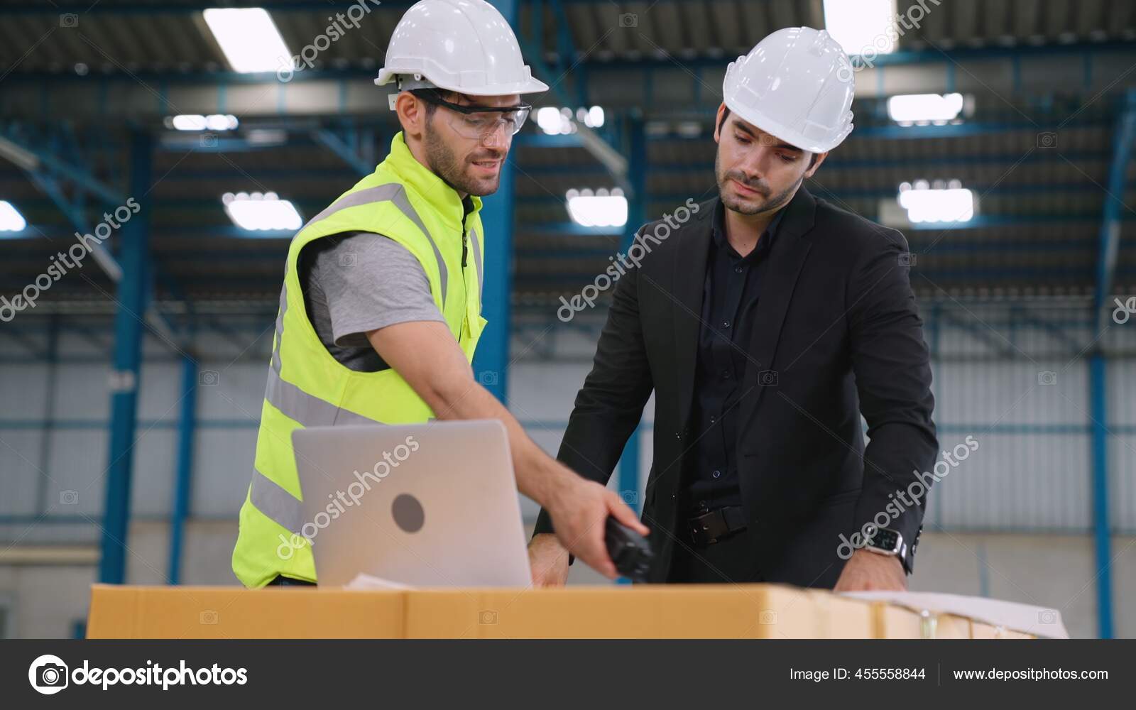 Two factory workers working and discussing manufacturing plan in the ...