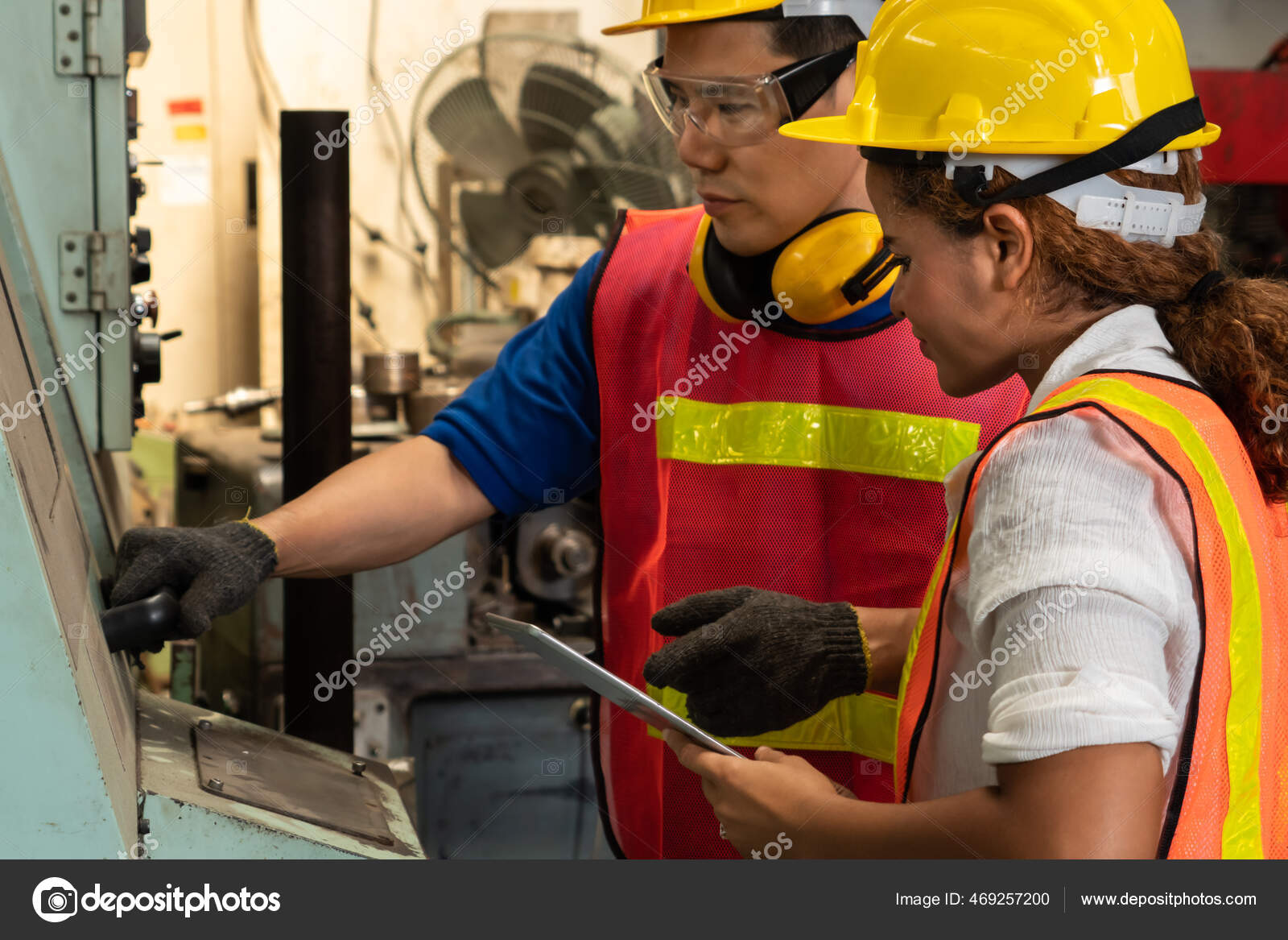 Group of skillful workers using machine equipment in factory workshop ...